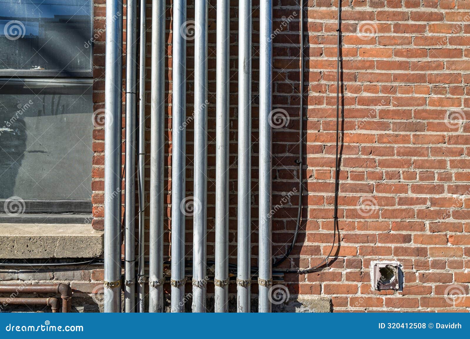 A Series of Metal Conduits Running Parallel Up and Down the Exterior ...