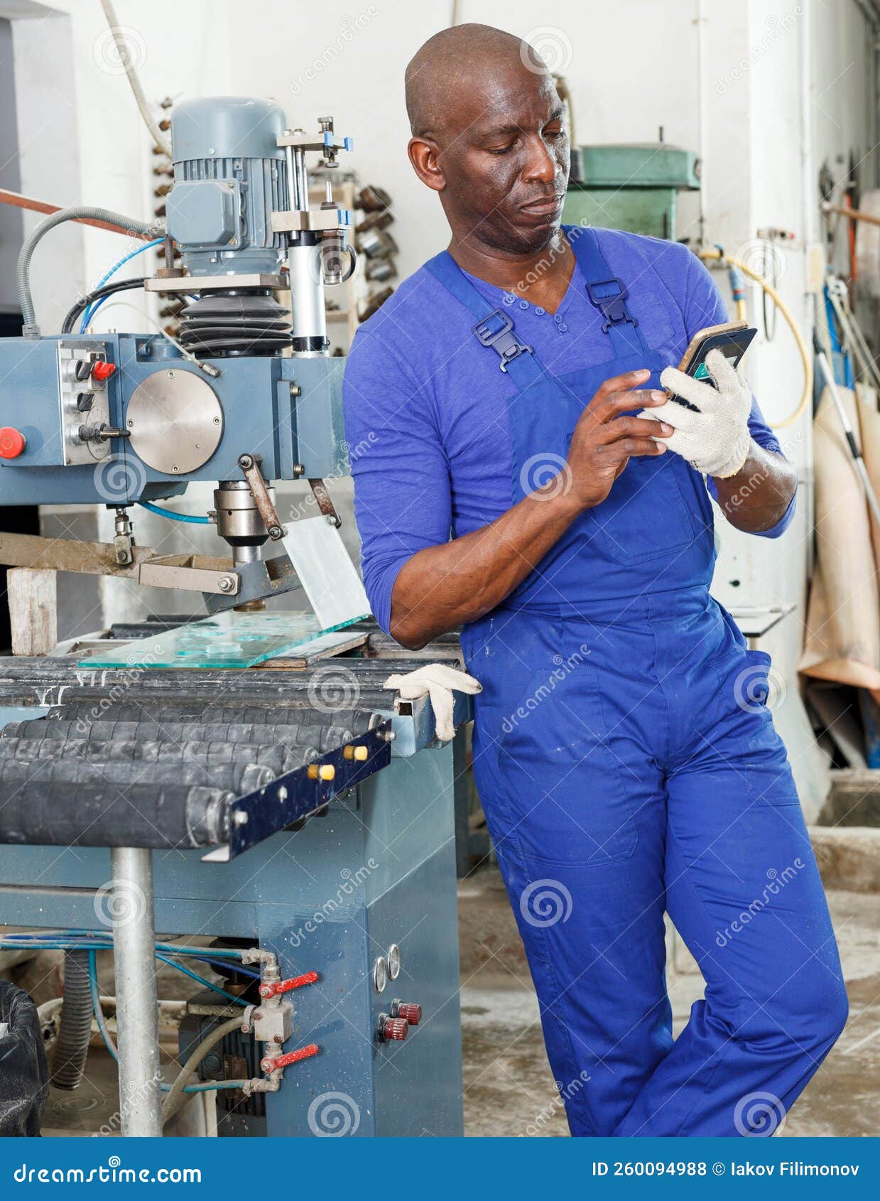 Worker using phone stock photo. Image of ethnicity, cutting - 260094988