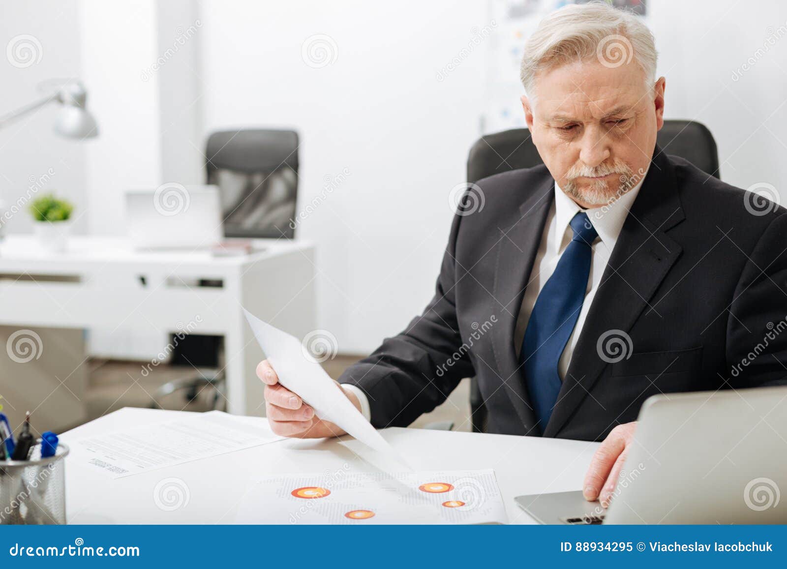Serious Aged Employer Working with Documents in the Office Stock Image ...