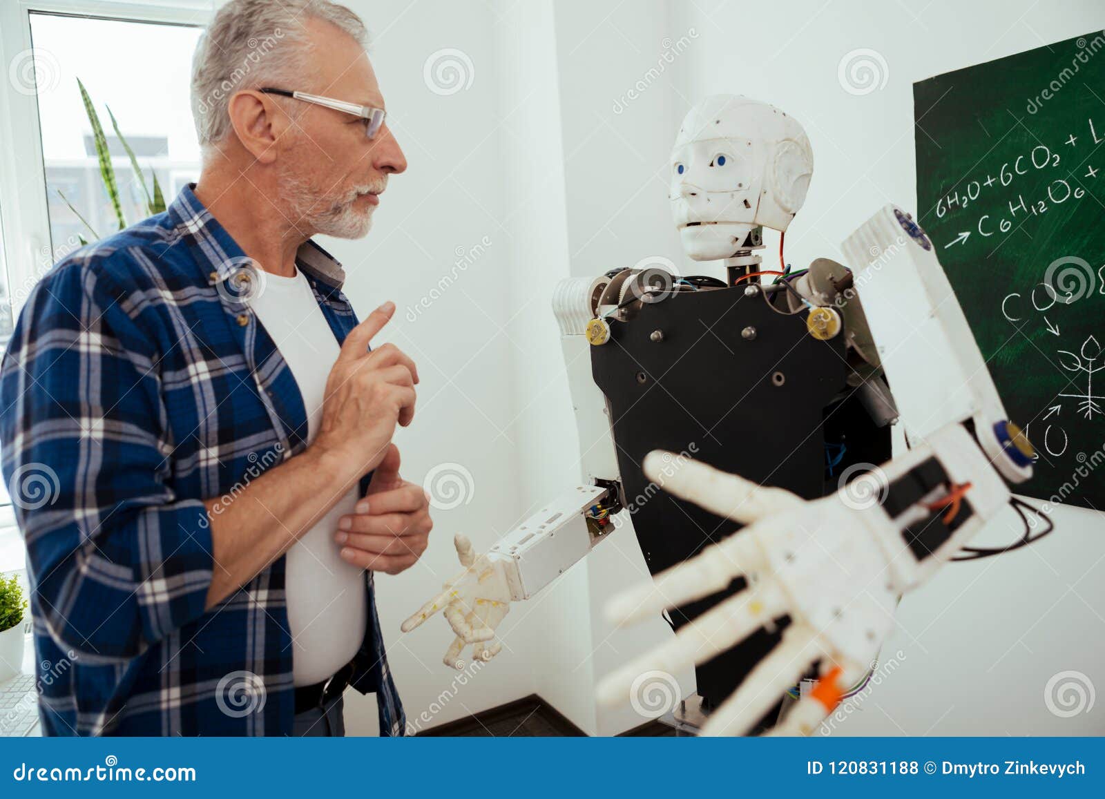 Serious Aged Man Standing in Front of the Robot Stock Photo - Image of ...