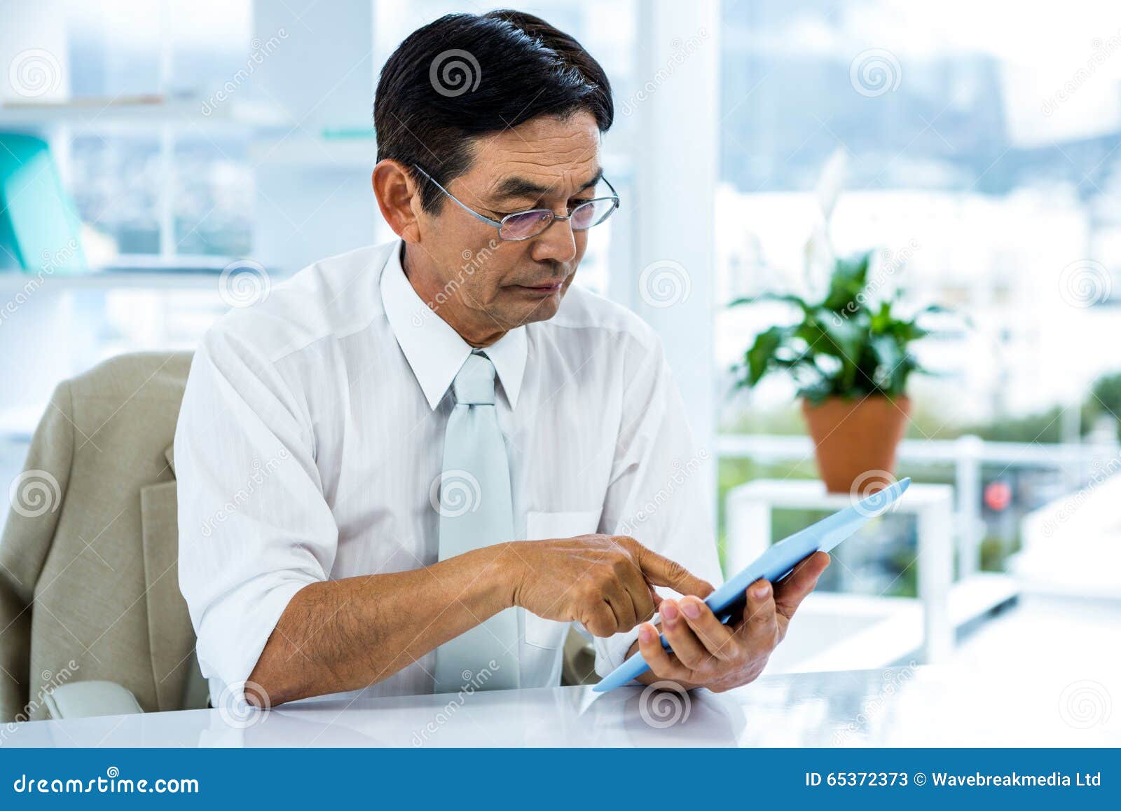 Serious Asian Businessman Using Tablet Stock Image - Image of smart ...