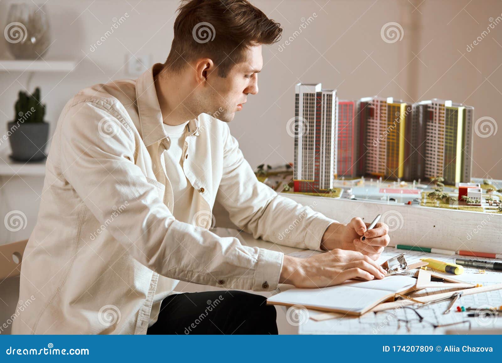 Serious Attractive Guy Drawing a New Building on Blueprint Stock Image ...