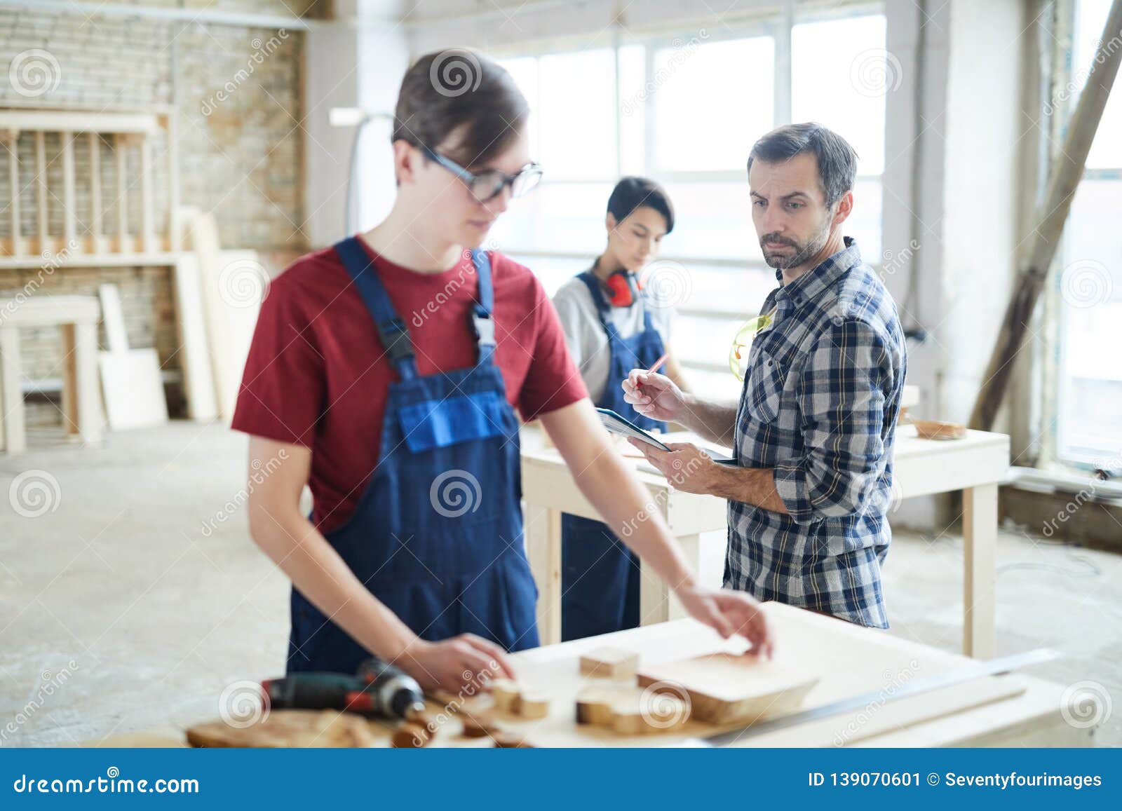 Serious Carpentry Teacher Checking Work of Students Stock Image - Image ...