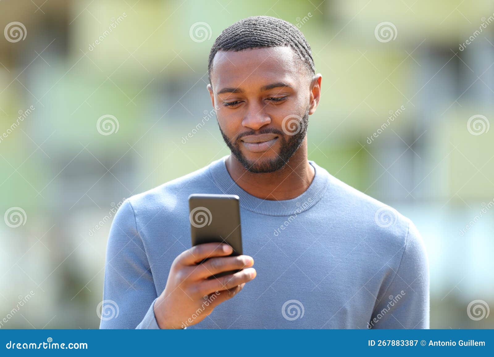 Serious Black Man Using Cellphone in the Street Stock Image - Image of ...