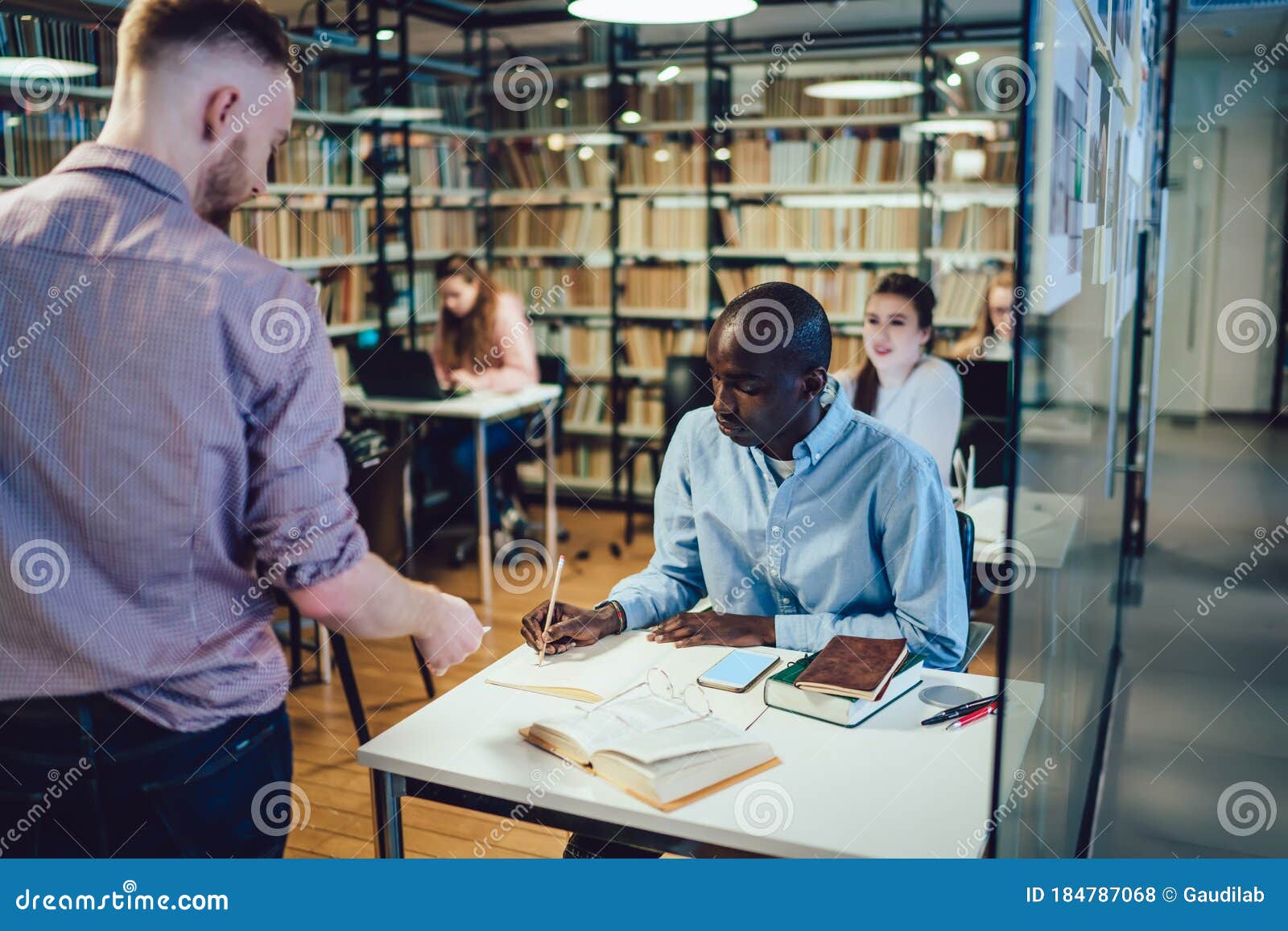 Serious Black Student Taking Notes and Using Smartphone in Class Stock ...