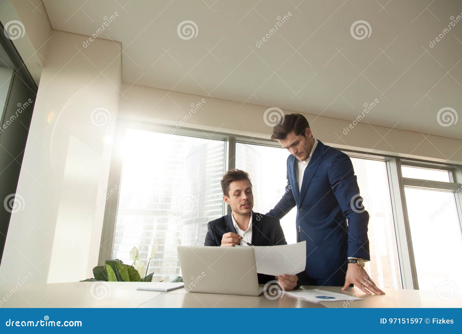 Serious Boss Talking To Employee, Reporting on Project, Showing Stock ...