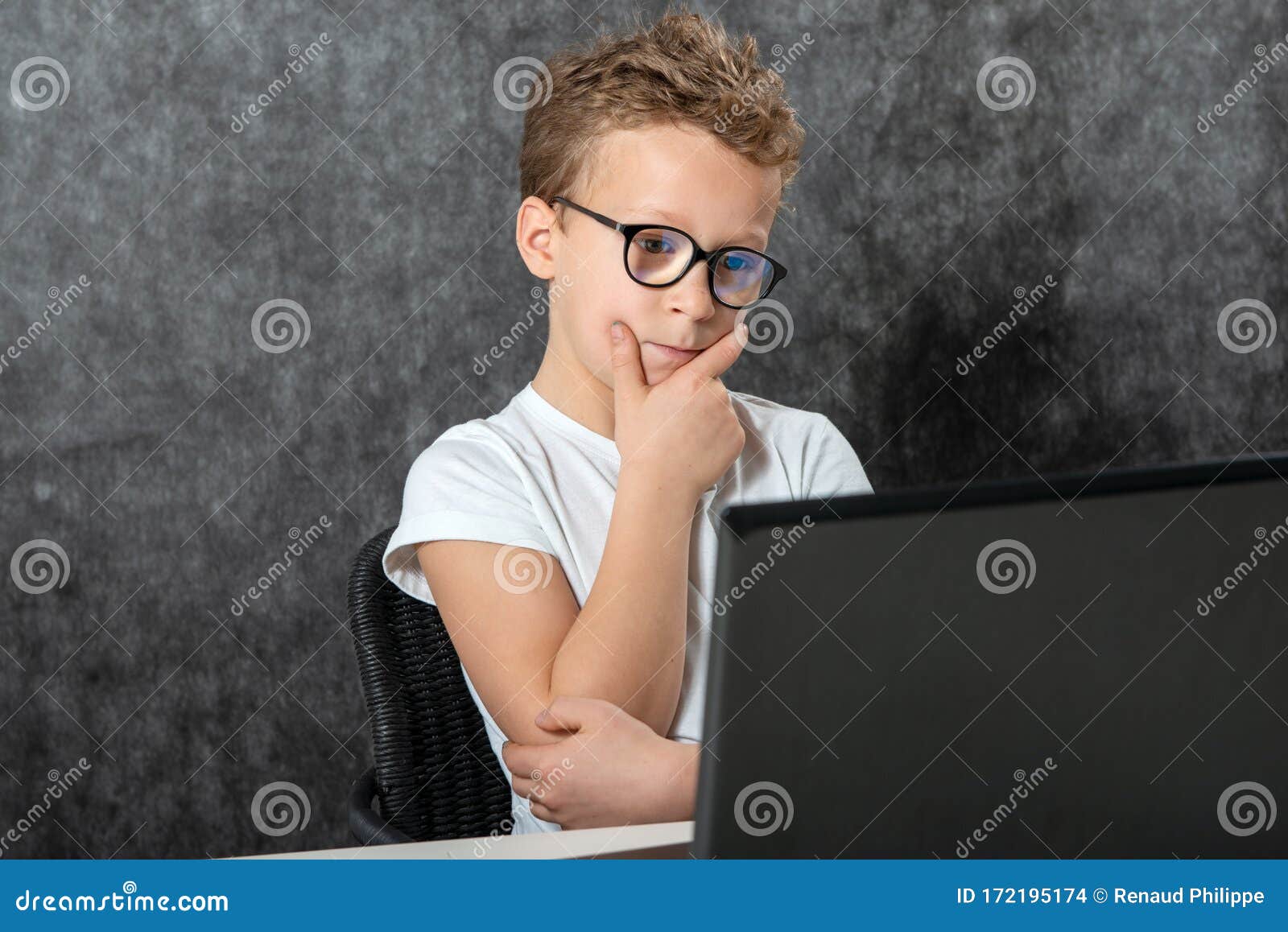 Serious Boy Sitting with Laptop Computer Stock Photo - Image of game ...