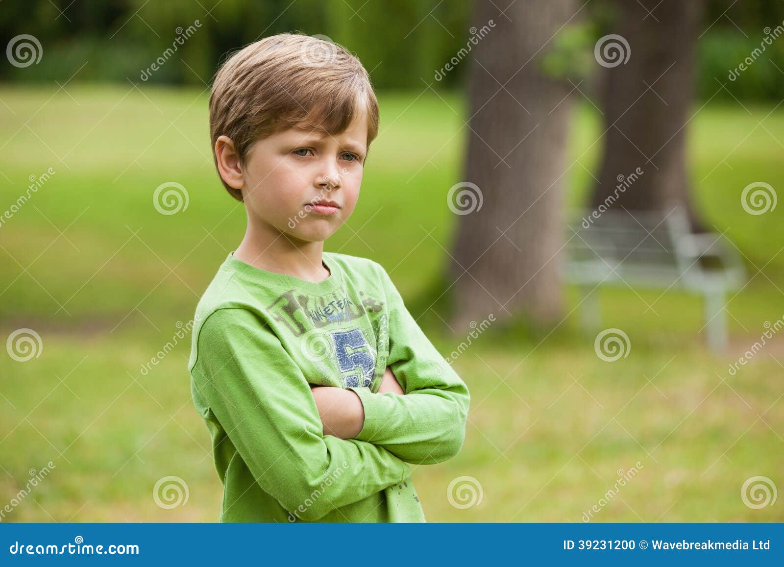 Serious Boy Standing with Arms Crossed at Park Stock Photo - Image of ...