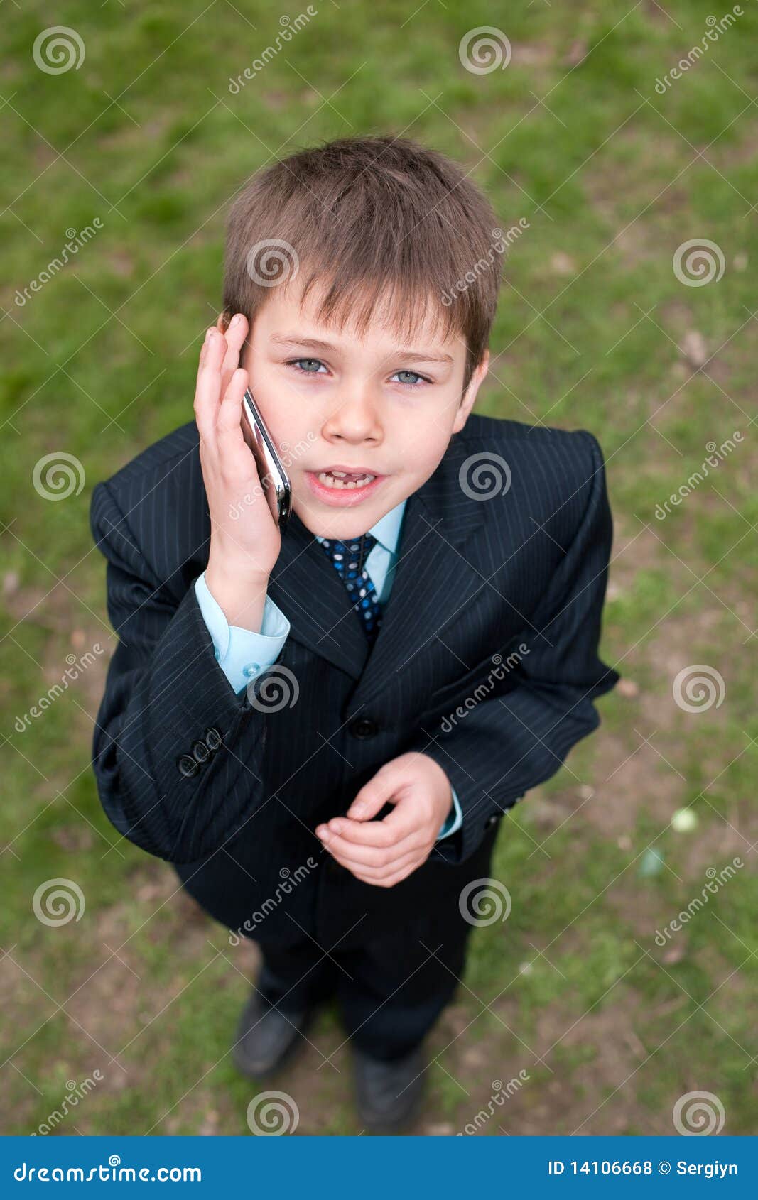 Serious Boy in Suit Speaking Over the Mobile Stock Photo - Image of ...