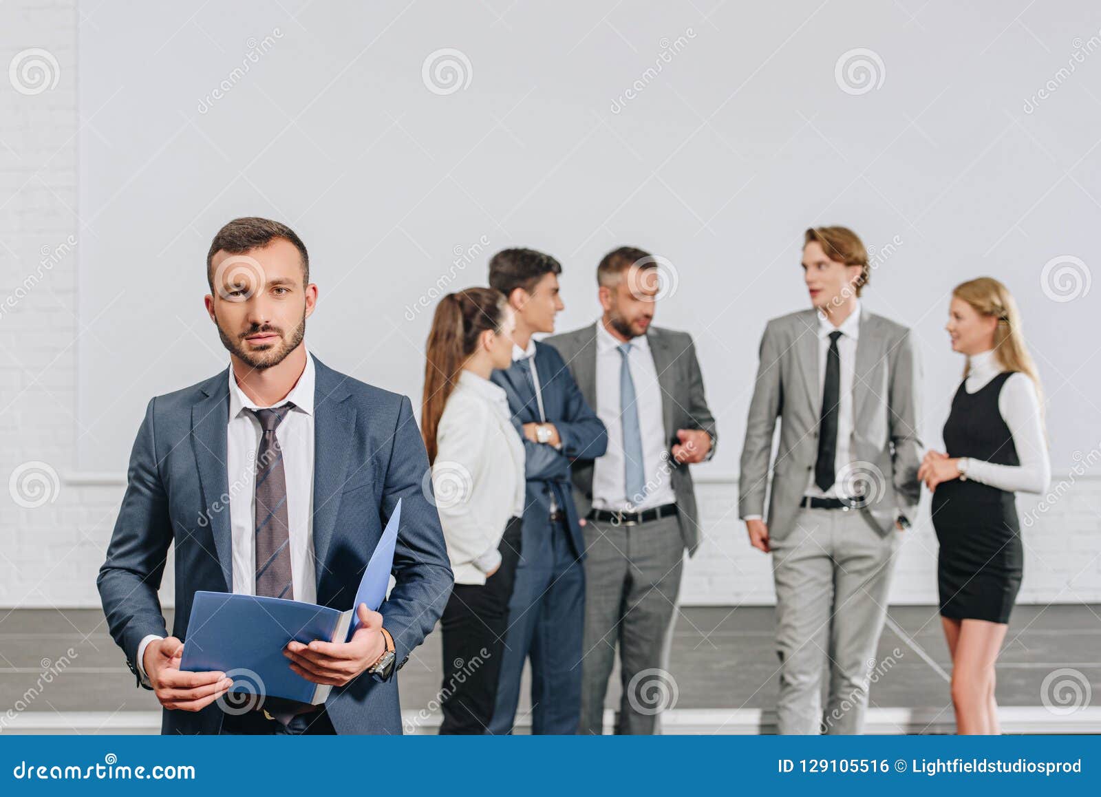 Serious Business Coach Holding Clipboard and Looking at Camera Stock ...