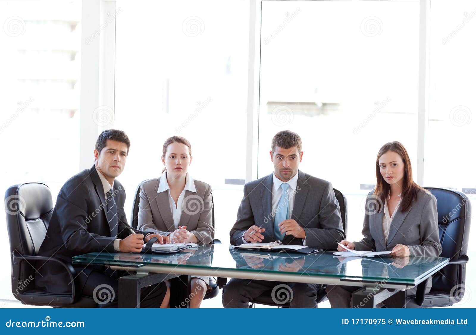 Serious Business Team Sitting Around a Table Stock Image - Image of ...