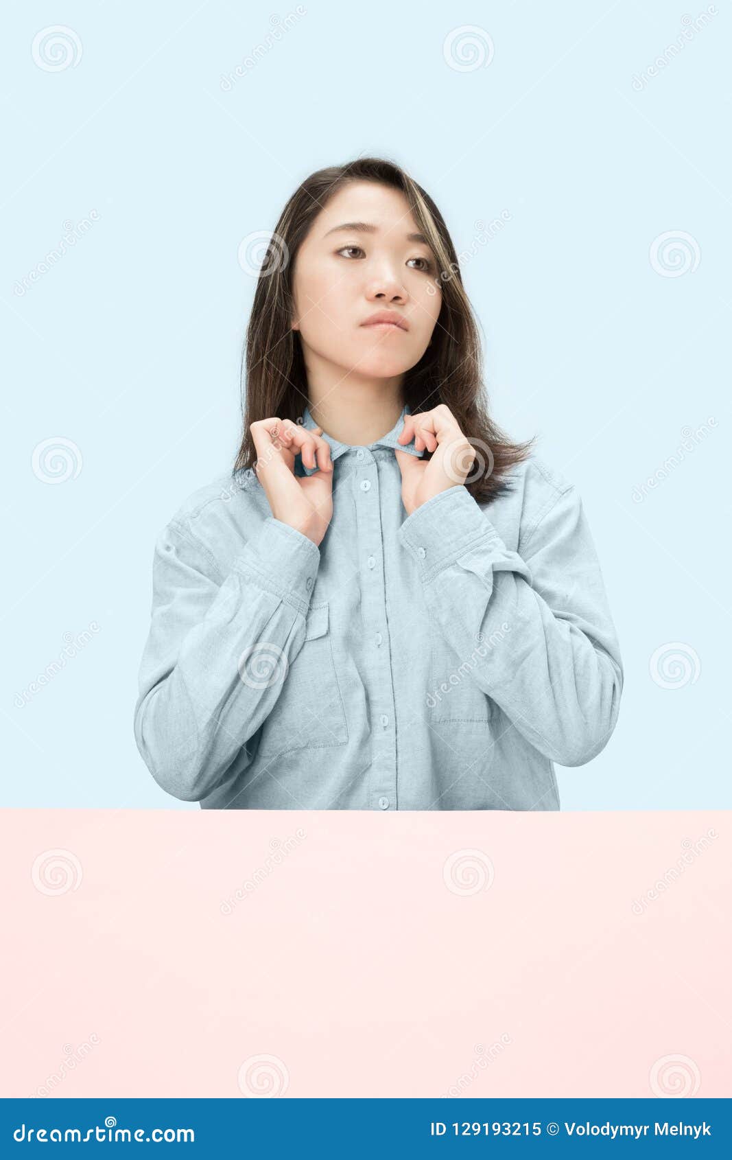 The Serious Business Woman Sitting and Looking at Left Against Blue ... The Serious Business Woman Sitting and Looking at Left Against Blue ...