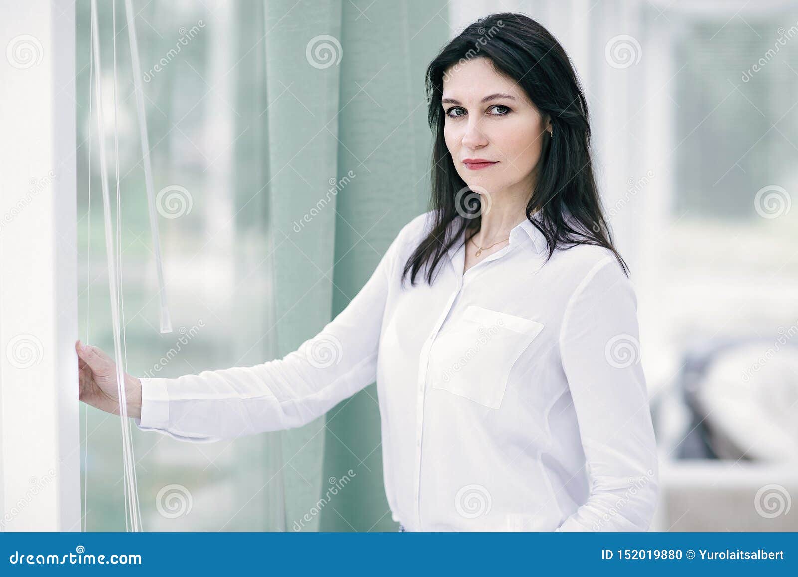 Serious Business Woman Standing Near The Window In The Office Stock