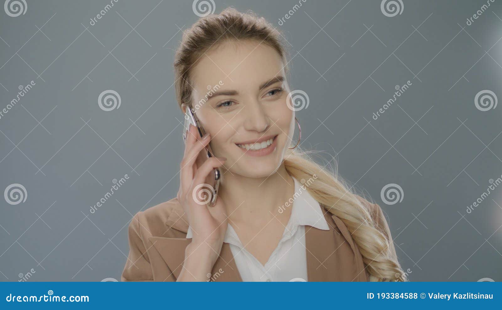 Serious Business Woman Talking Mobile Phone On Gray Background Stock