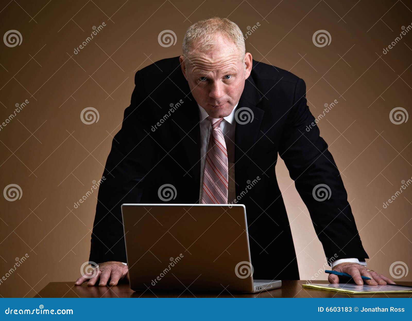 Serious Businessman Leaning Over Laptop Stock Image - Image of adult ...