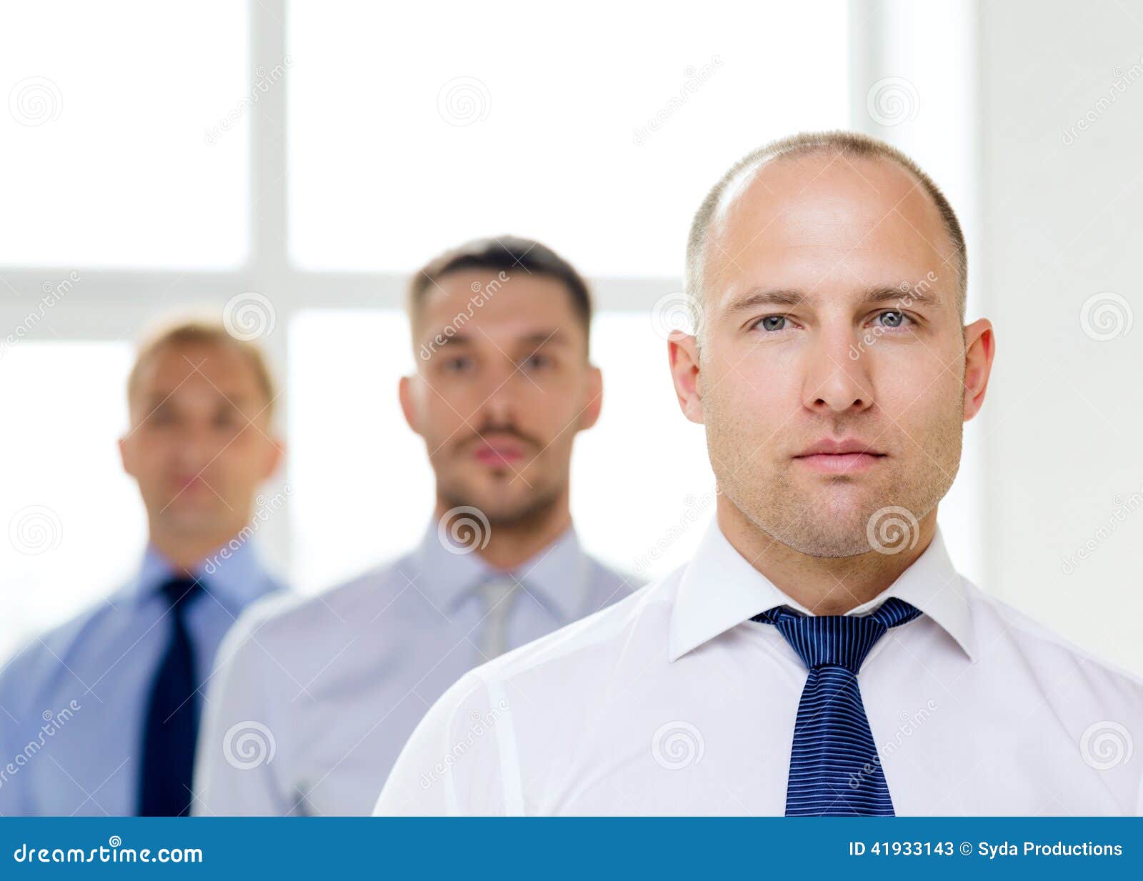 Serious Businessman in Office with Team on Back Stock Image - Image of ...