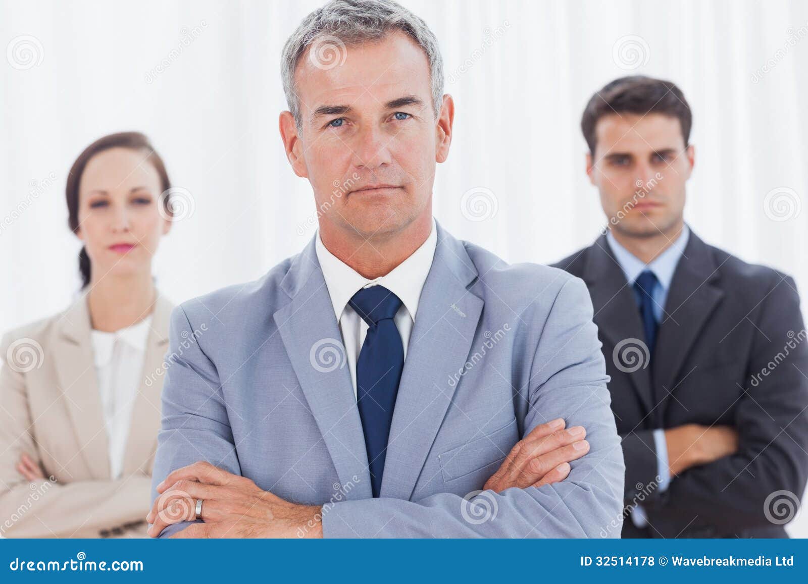 Serious Businessman Posing with His Work Team Stock Photo - Image of ...