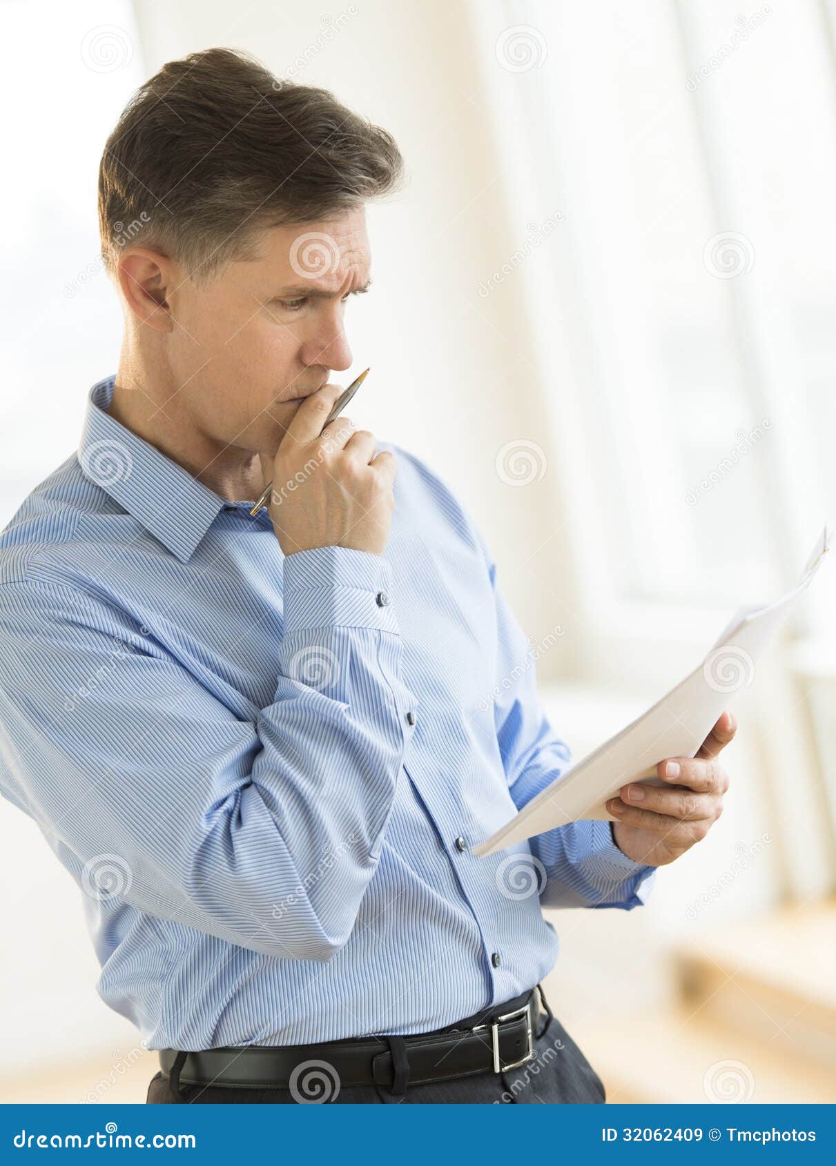 Serious Businessman Reading Document Stock Image - Image of business ...