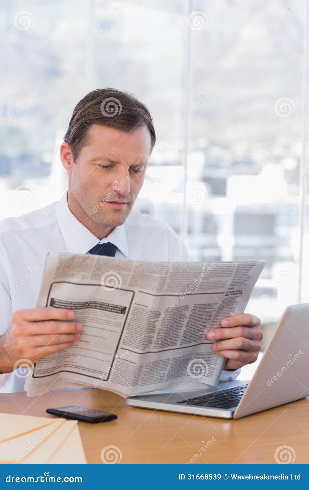 Serious Businessman Reading a Newspaper Stock Image - Image of ...