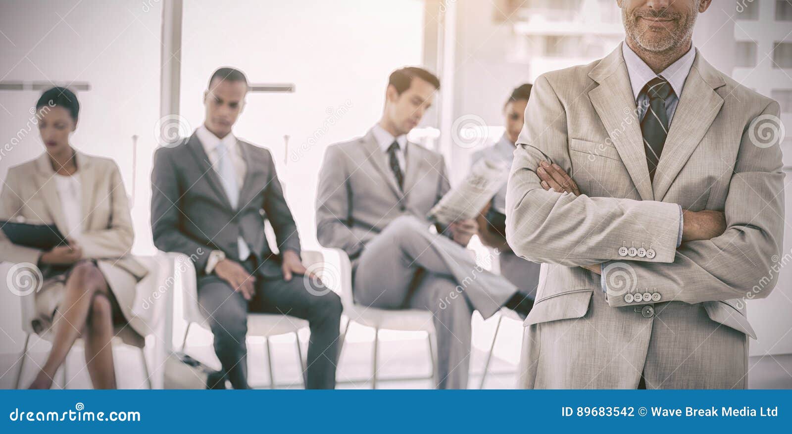 Serious Businessman Standing in Front of Business People Stock Photo ...