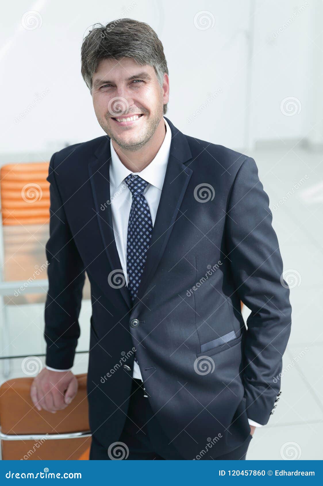 Serious Businessman Standing Near Workplace in Office. Stock Photo ... Serious Businessman Standing Near Workplace in Office. Stock Photo ...
