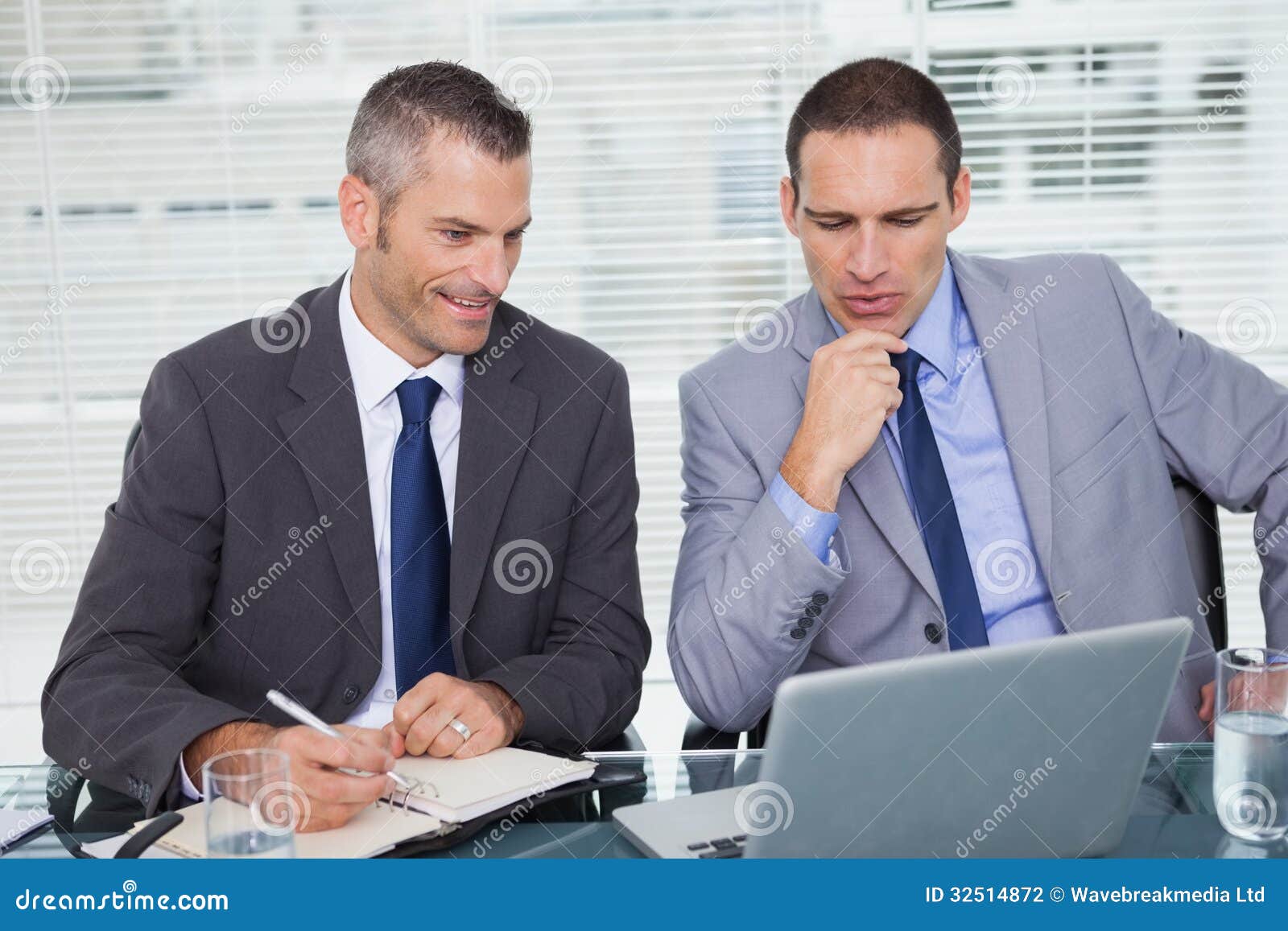 Serious Businessmen Analyzing Application Stock Photo - Image of ...