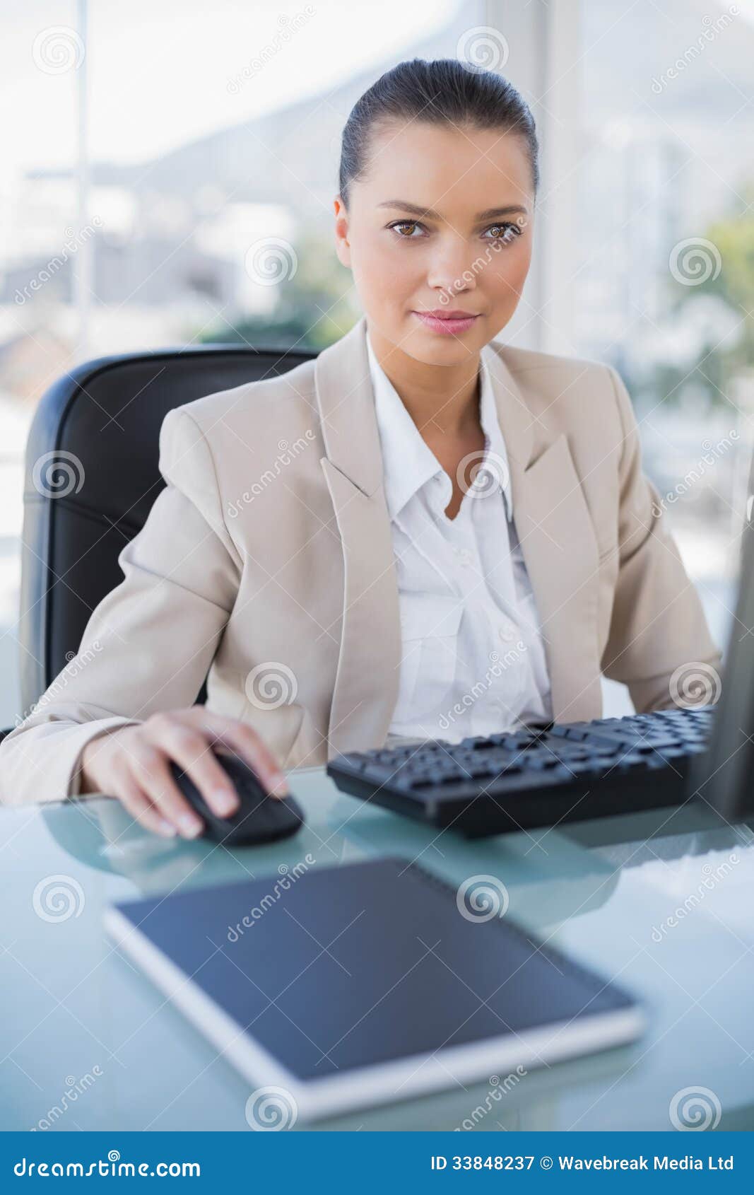 Serious Businesswoman Working on Computer Looking at Camera Stock Image ...