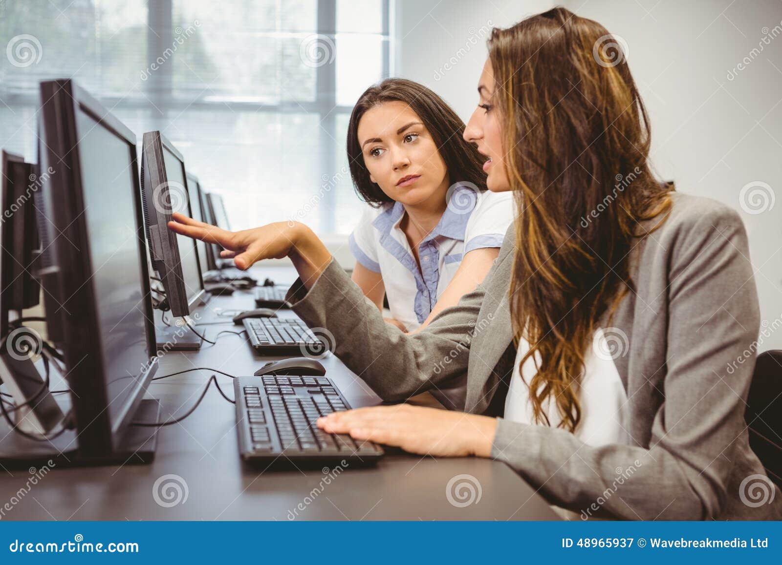 Serious Businesswomen Looking at Computer Screen Together Stock Image ...