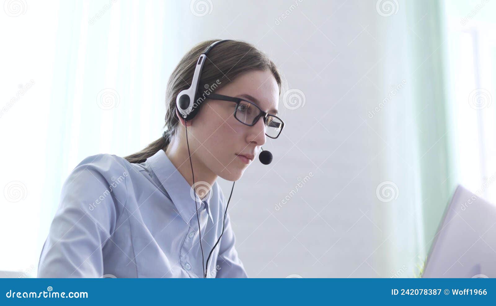 Serious Call Center Operator in Wireless Headset Talking with Customer ...