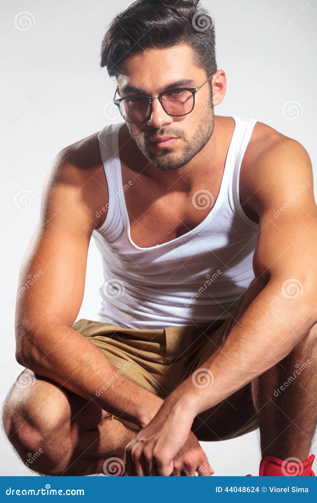Serious Casual Man in Undershirt Standing Crouched Stock Photo - Image ...