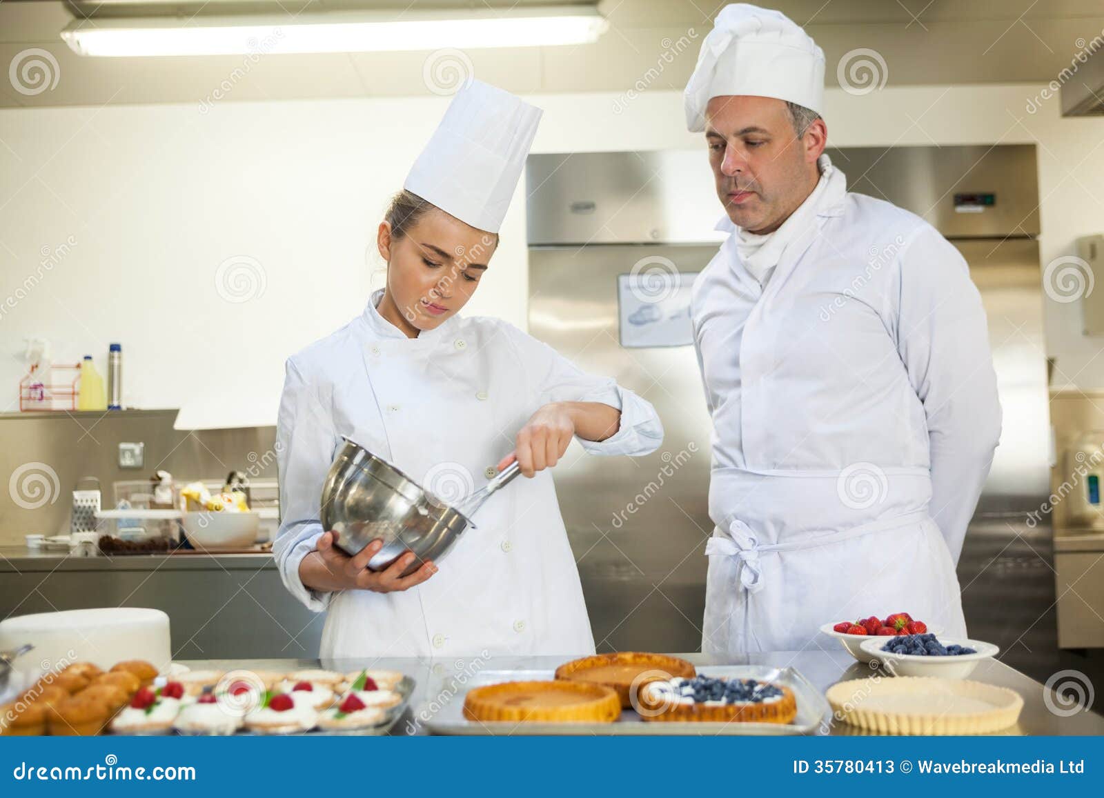 Serious Chef Whisking while Being Watched by Head Chef Stock Image ...