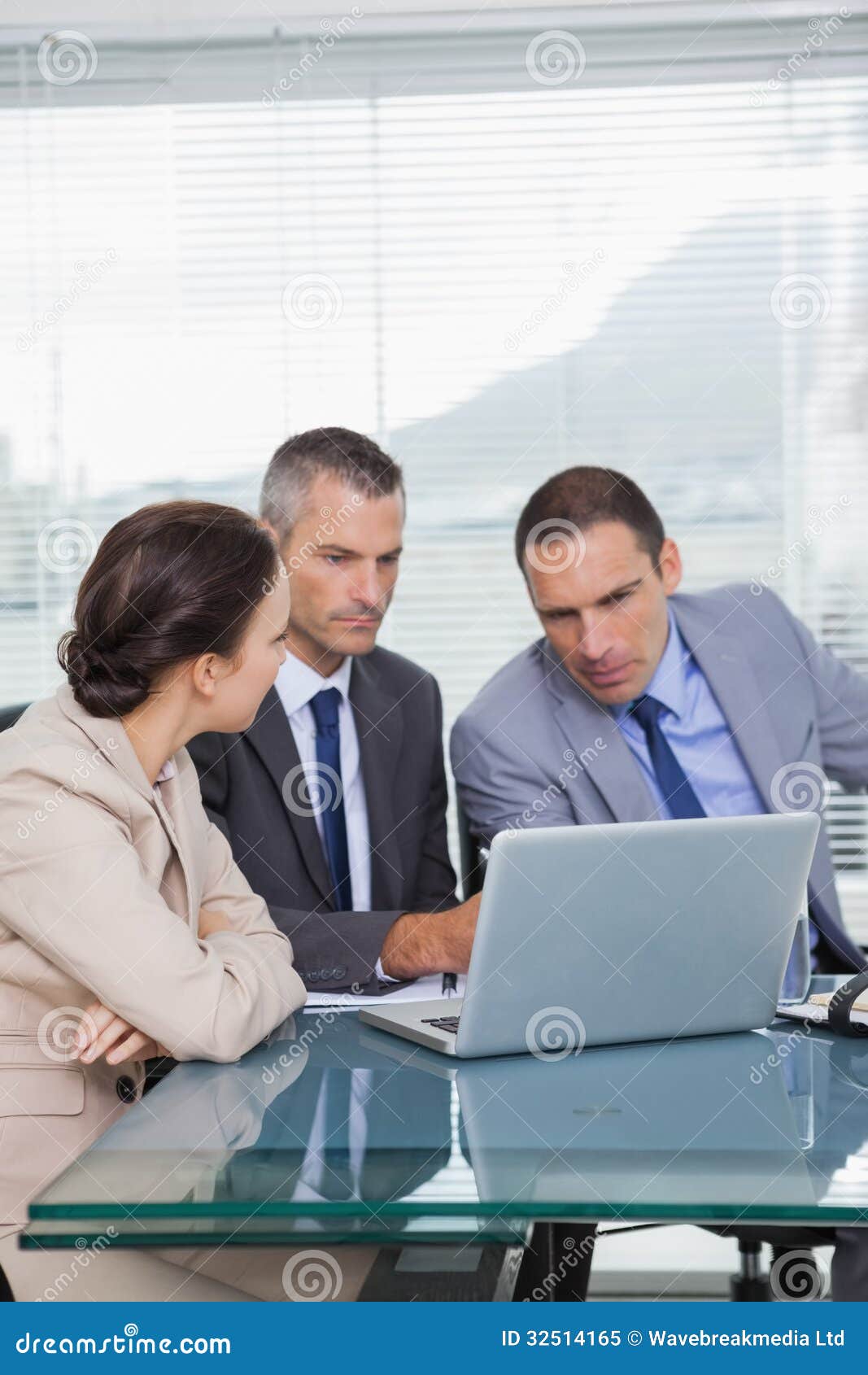 Serious Colleagues Working Together on Their Laptop Stock Image - Image ...