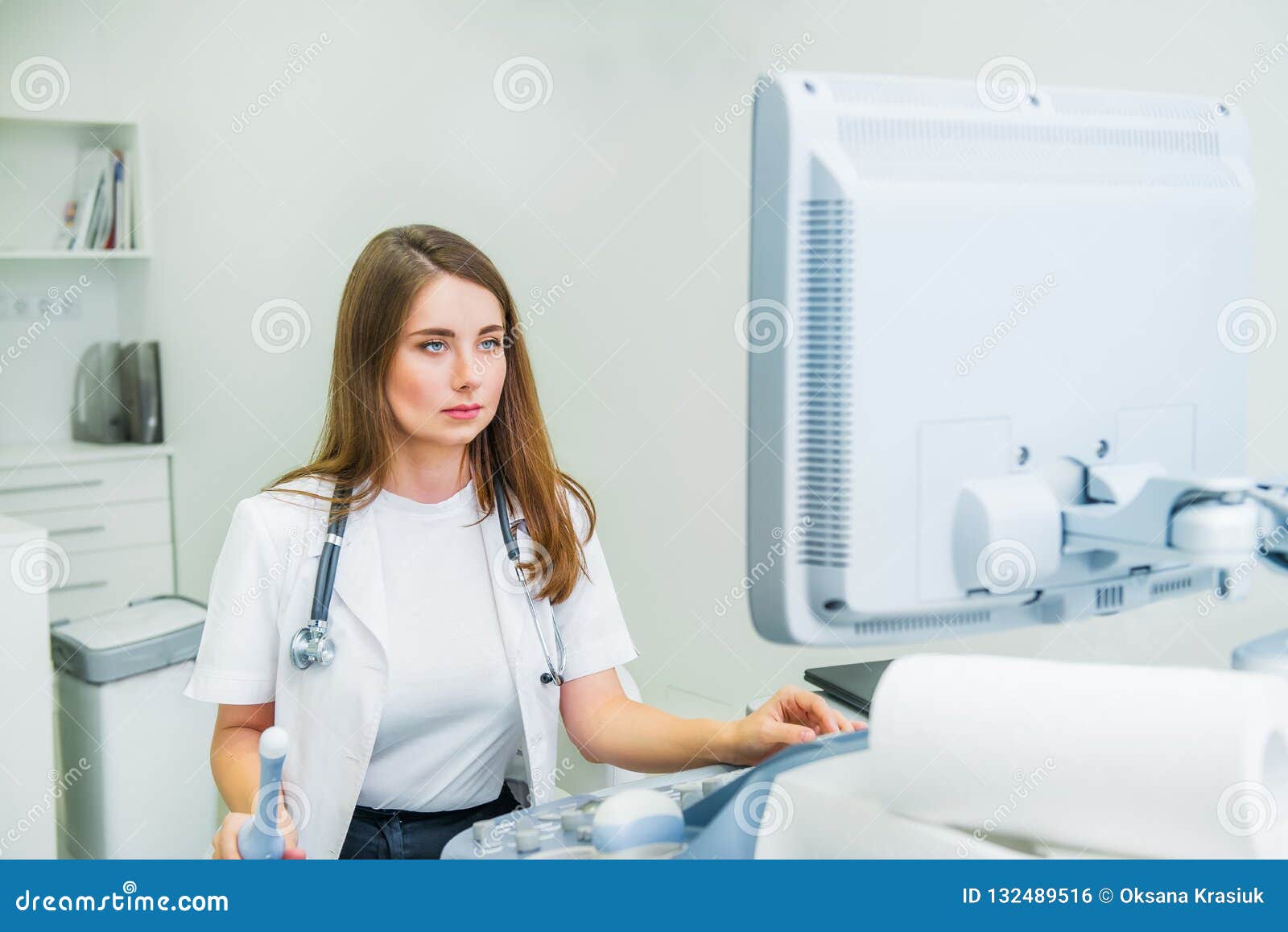 Serious, Concentrated Young Doctor, Specialist Using Ultrasound ...