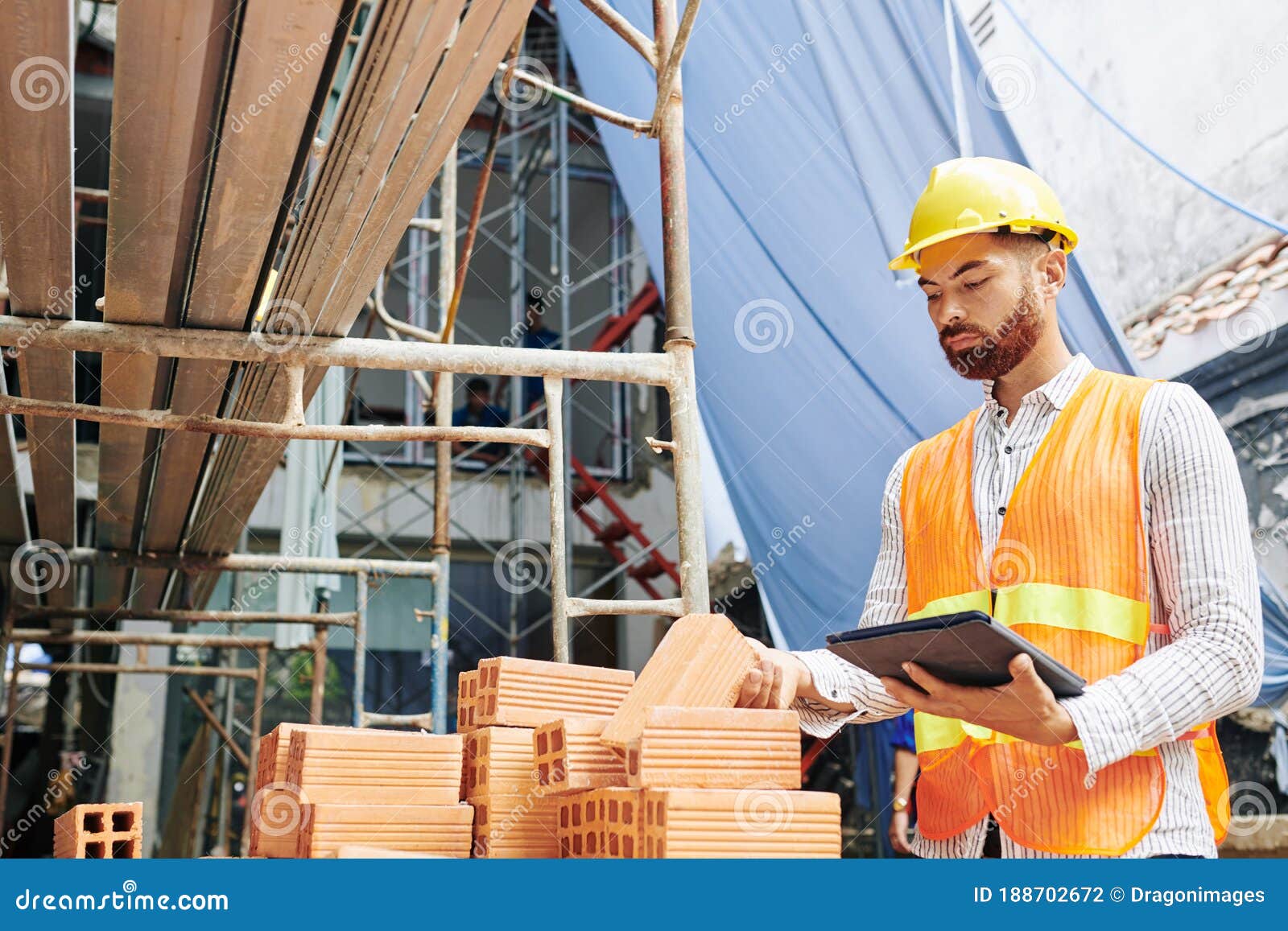 Contractor checking bricks stock photo. Image of equipment - 188702672