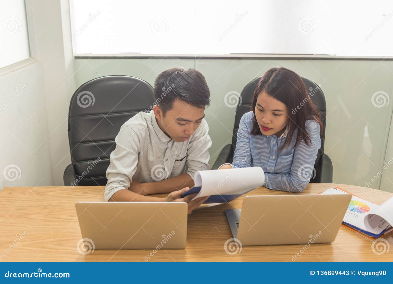 Serious Conversation between Two Asian Business Employees at Work Stock ...