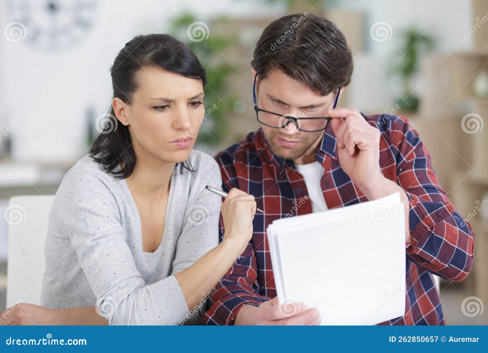 Serious Couple Reading Paperwork Together Stock Image - Image of ...