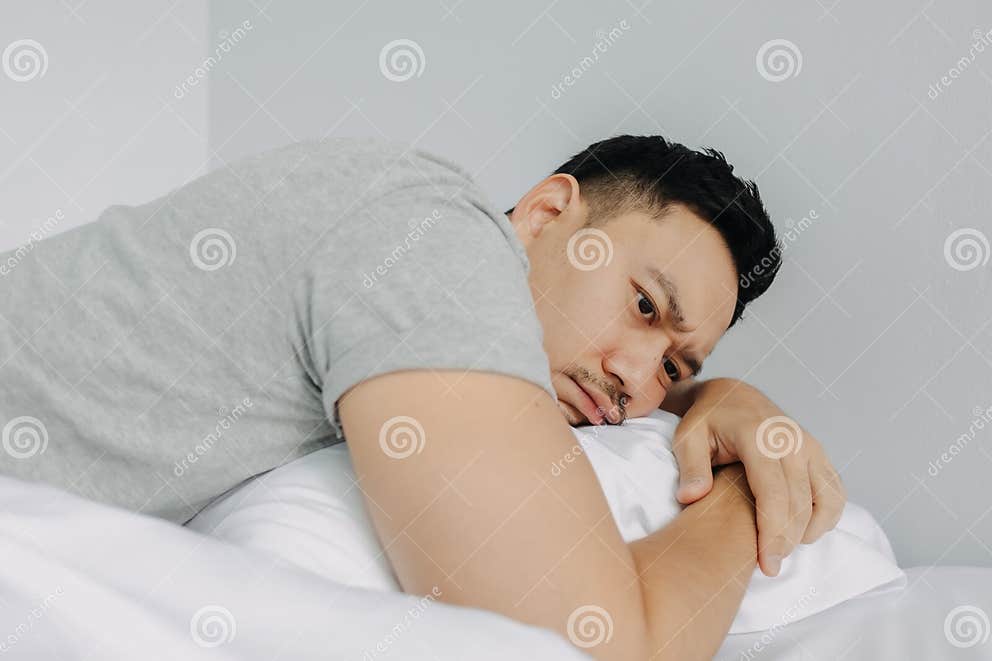 Serious and Depressed Man Overthinking the Problems Lying on the Bed ...