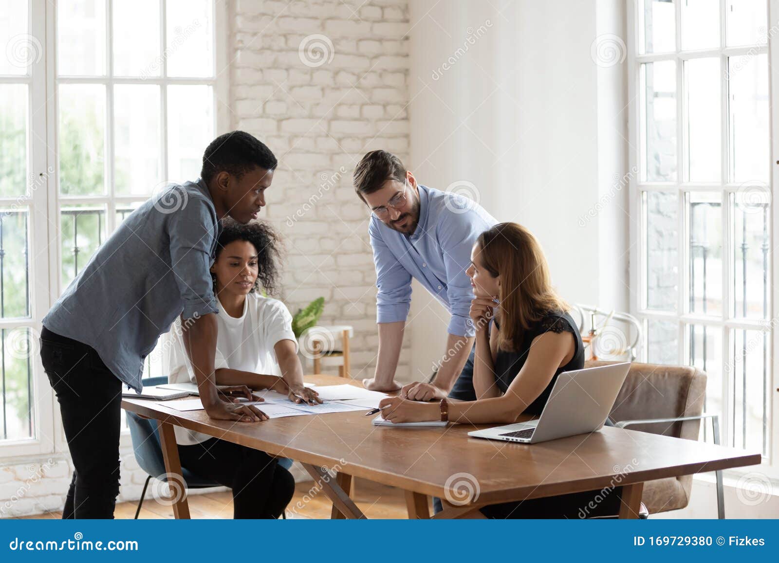 Serious Diverse Business People Working on Project Documents at Meeting ...