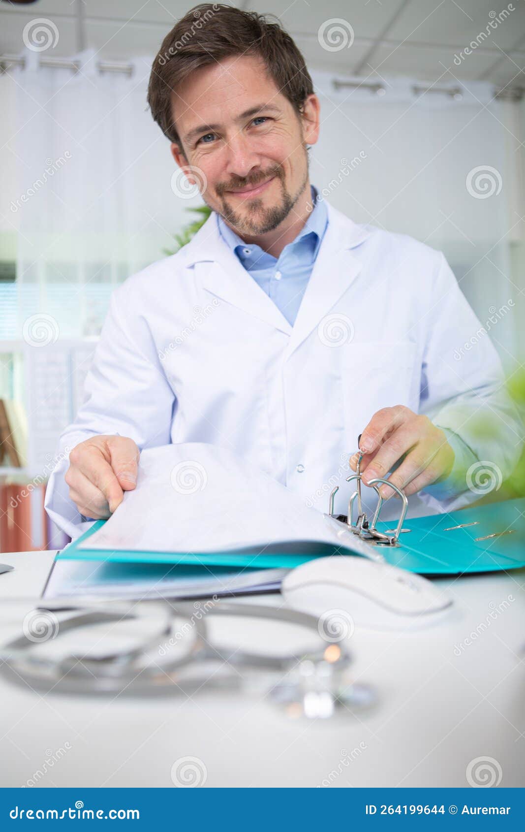 Serious Doctor with Binder Looking at Files Stock Photo - Image of ...
