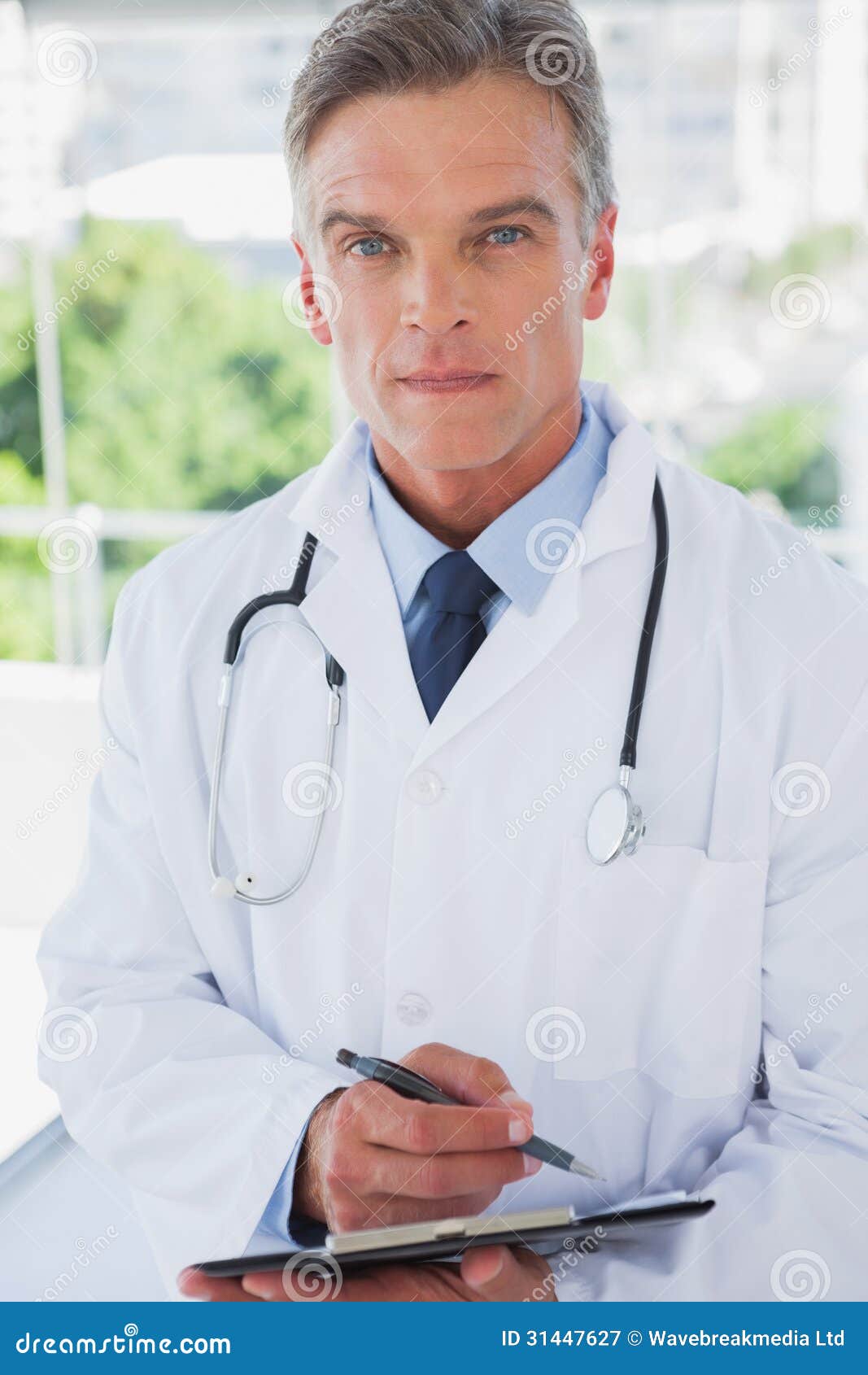 Serious Doctor Standing with a Clipboard Stock Image - Image of ...