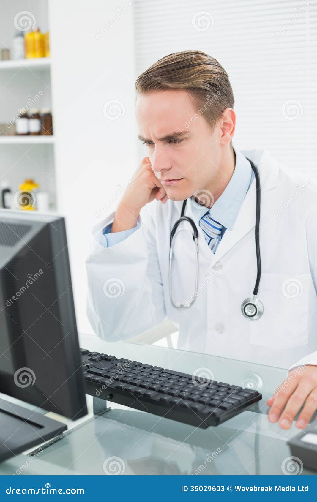 Serious Doctor Using Computer at Medical Office Stock Image - Image of ...