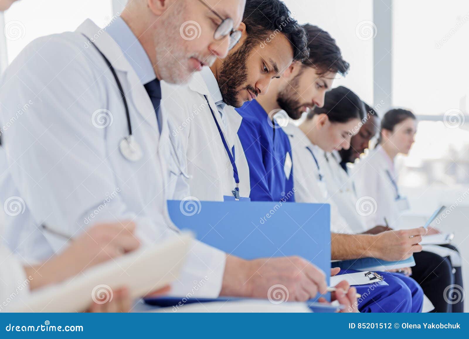 Serious Doctors Reading Documents Together Stock Photo - Image of ...