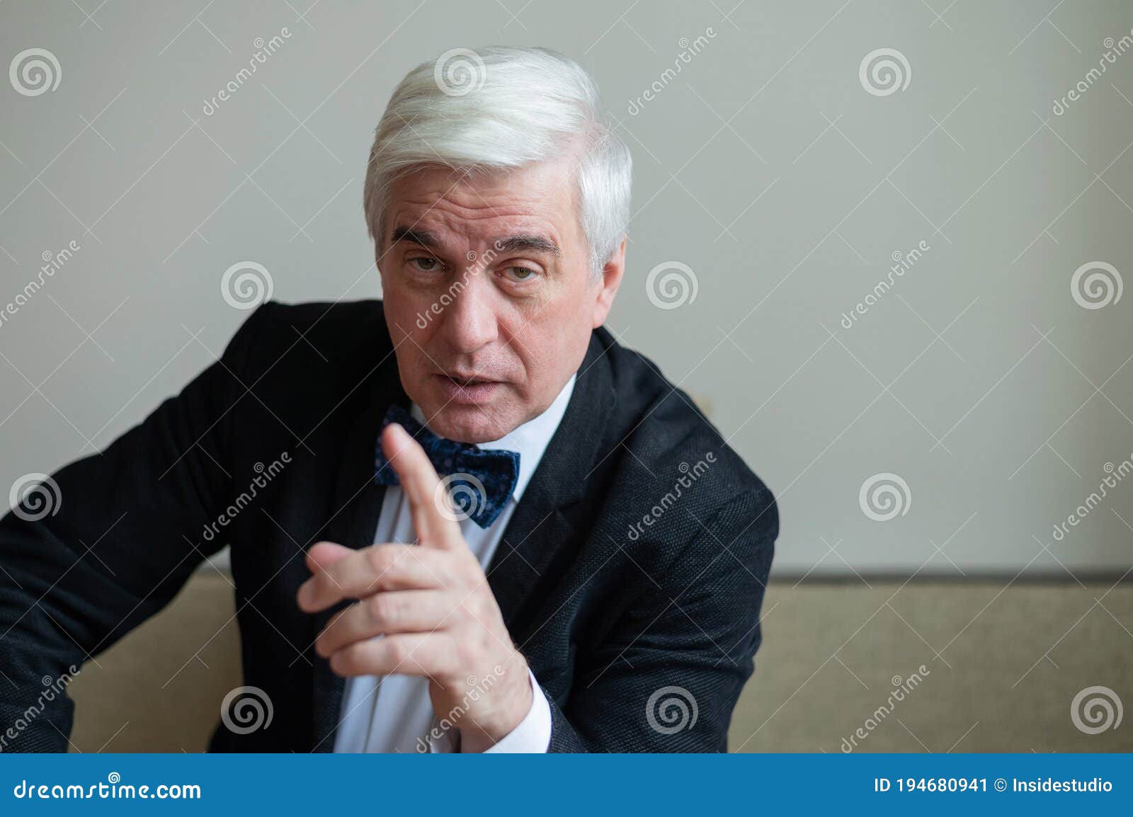 A Serious Elderly Man in a Suit Points His Finger. Stock Image - Image ...