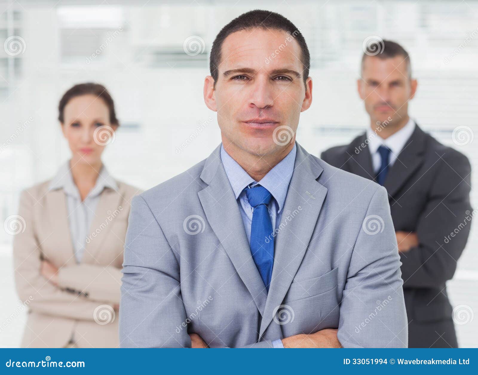 Serious Employee Posing With His Colleagues On Background Stock Photo ...