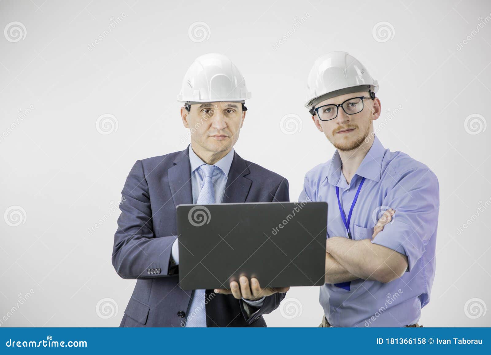 Serious Engineer and Architect in Hard Hats Looks at Camera, Discuss ...