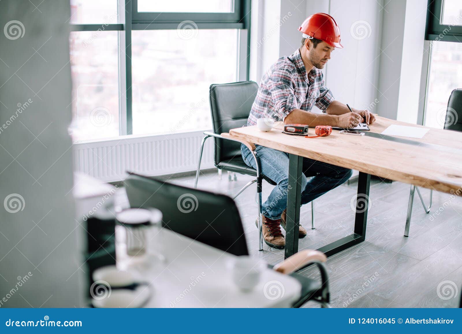 Serious Engineer is Concentrated on Paperwork at Workplace Stock Image ...