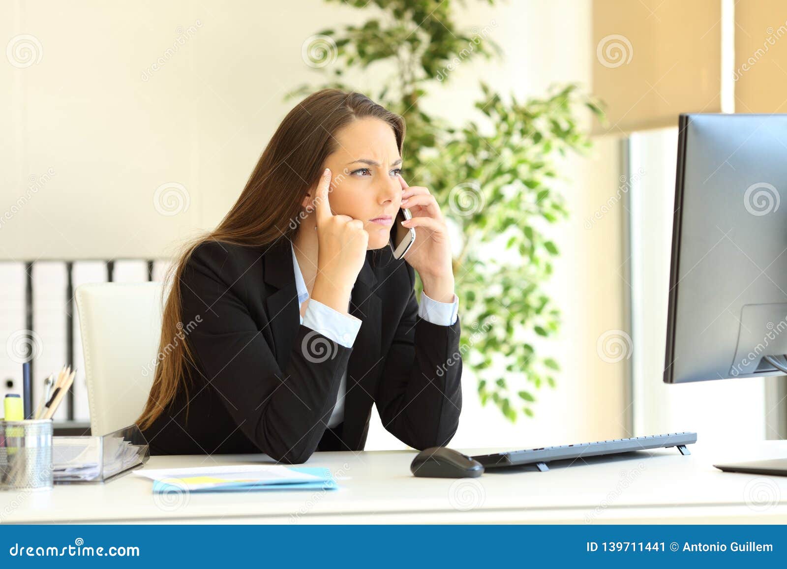 Serious Executive Calling on Phone Checking Computer Stock Image ...
