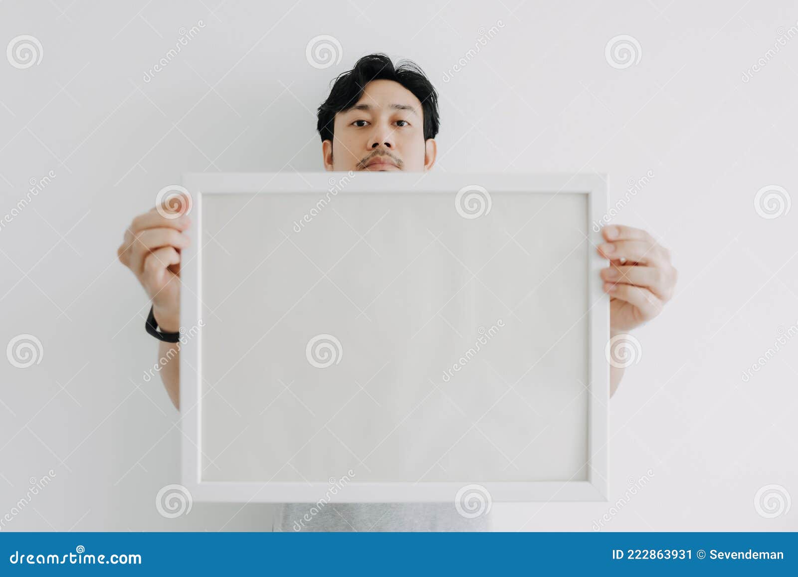 Serious Face Man Holding an Empty Frame Isolated on White Background ...