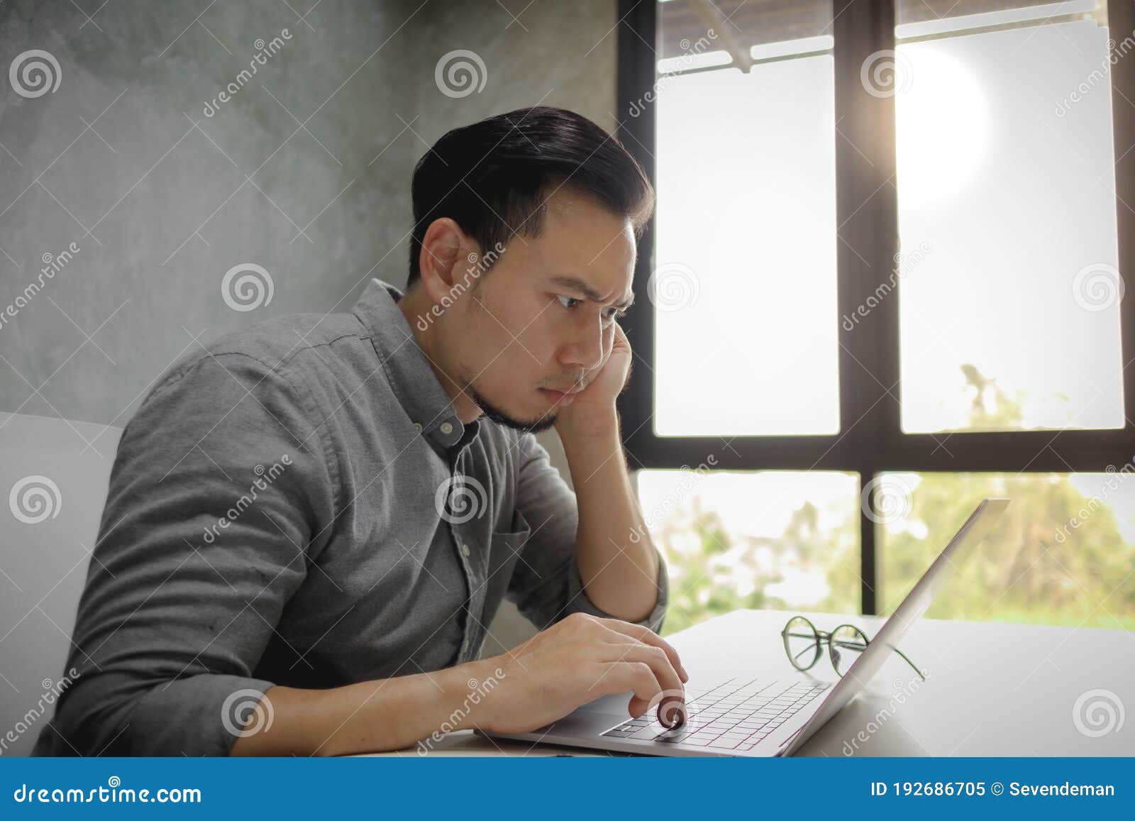 Serious Face of Man Working on Laptop Alone in the Room. Stock Image ...