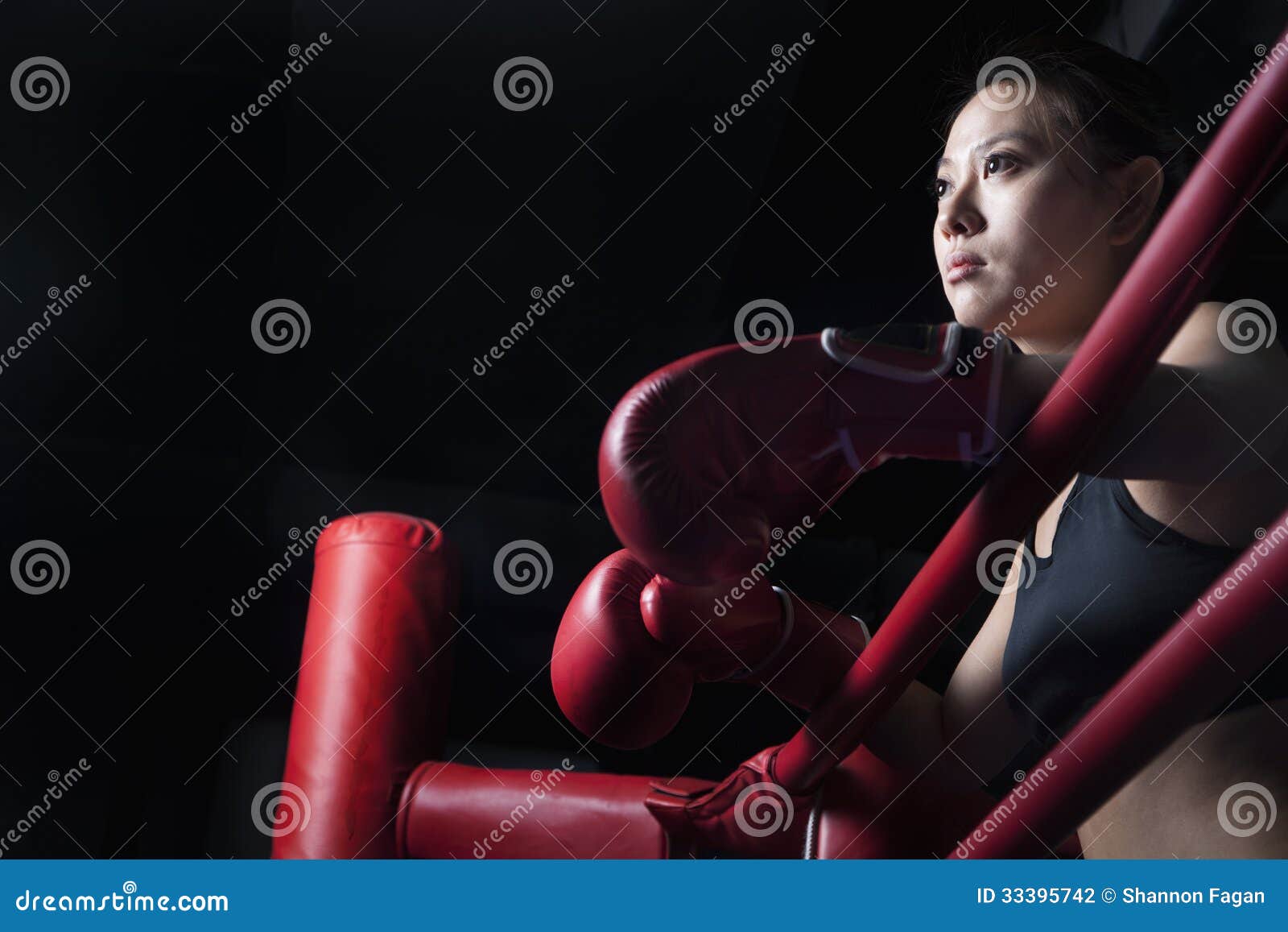Serious Female Boxer Resting Her Elbows on the Ring Side, Looking Away ...
